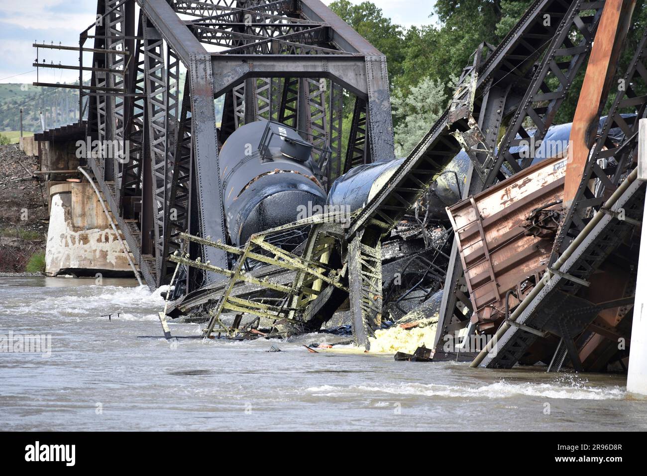 Several train cars are immersed in the Yellowstone River after a bridge ...