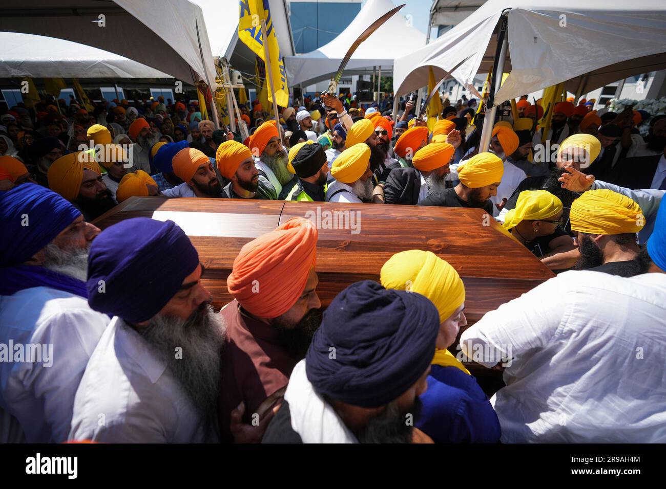 Mourners carry the casket of Sikh community leader and temple president Hardeep Singh Nijjar ...