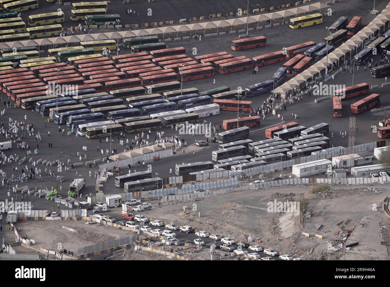 People walk at a giant bus station outside the Grand mosque in the ...