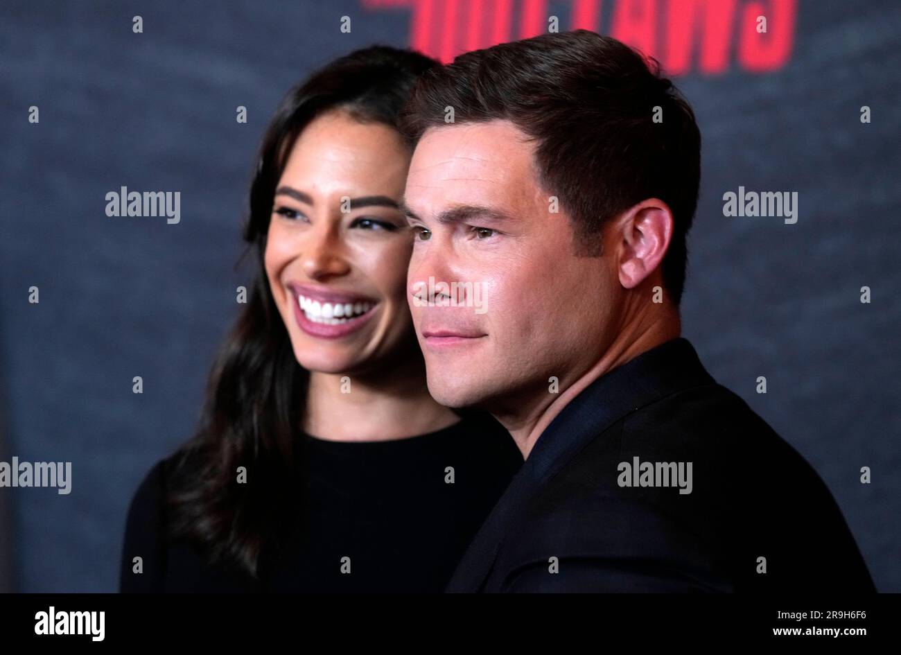 Adam Devine, right, poses with his wife Chloe Bridges at a special ...