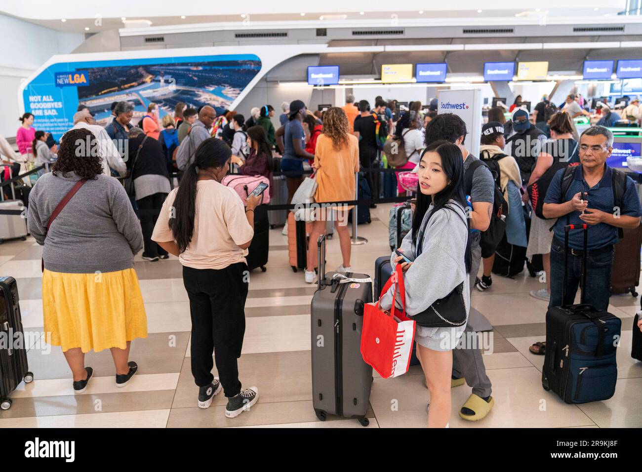 Travelers line up at the Southwest Airline ticket counter in the ...