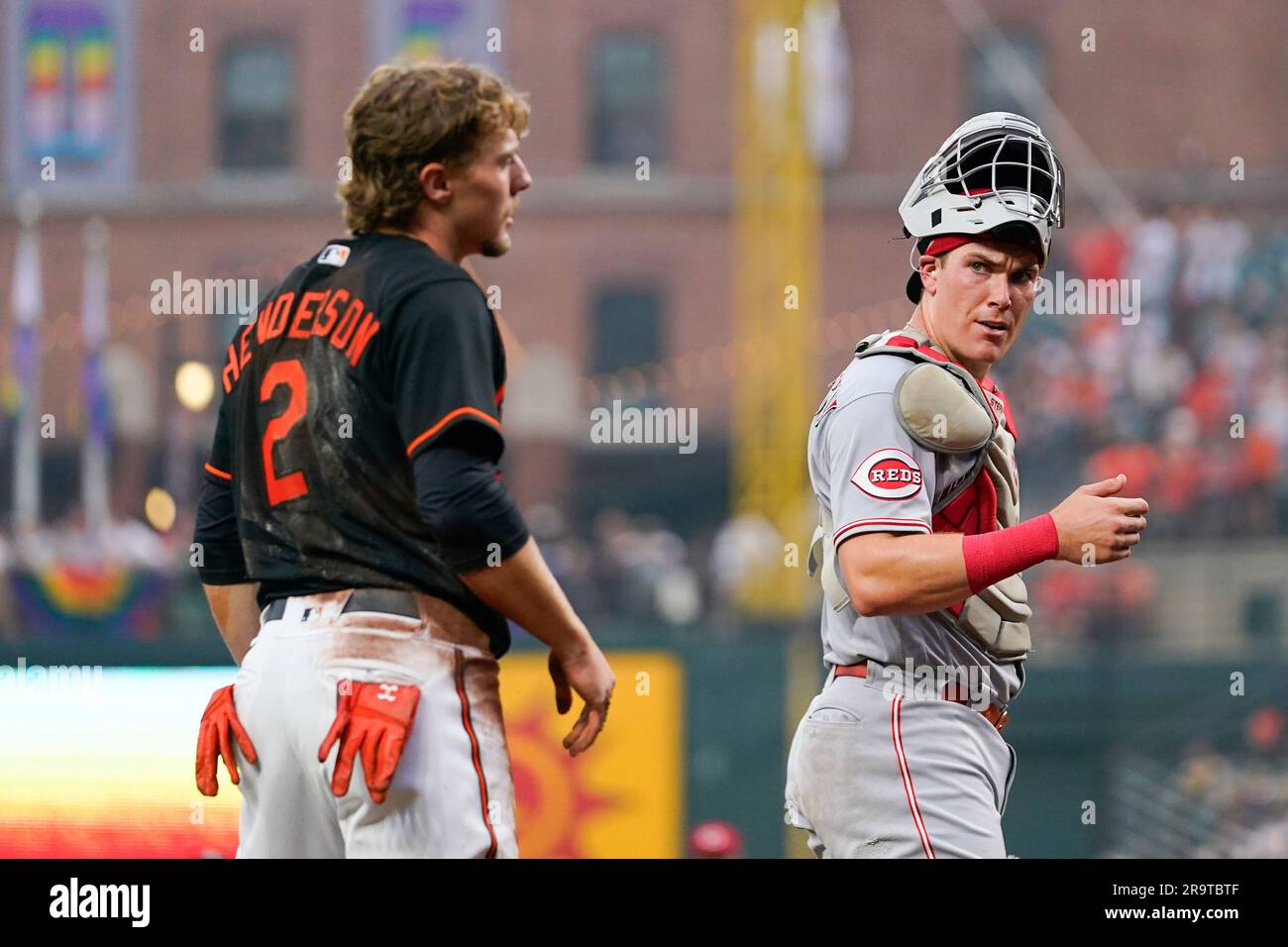 Cincinnati Reds catcher Tyler Stephenson, right, looks back toward his ...