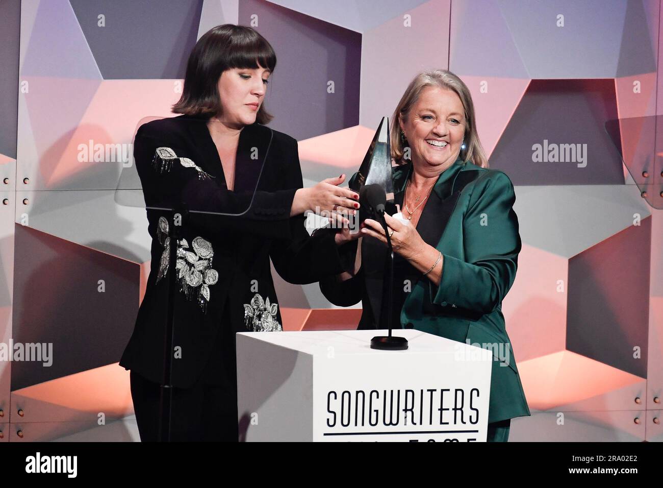 Caitlin Rose, left, inducts her mother Liz Rose at the 52nd annual ...