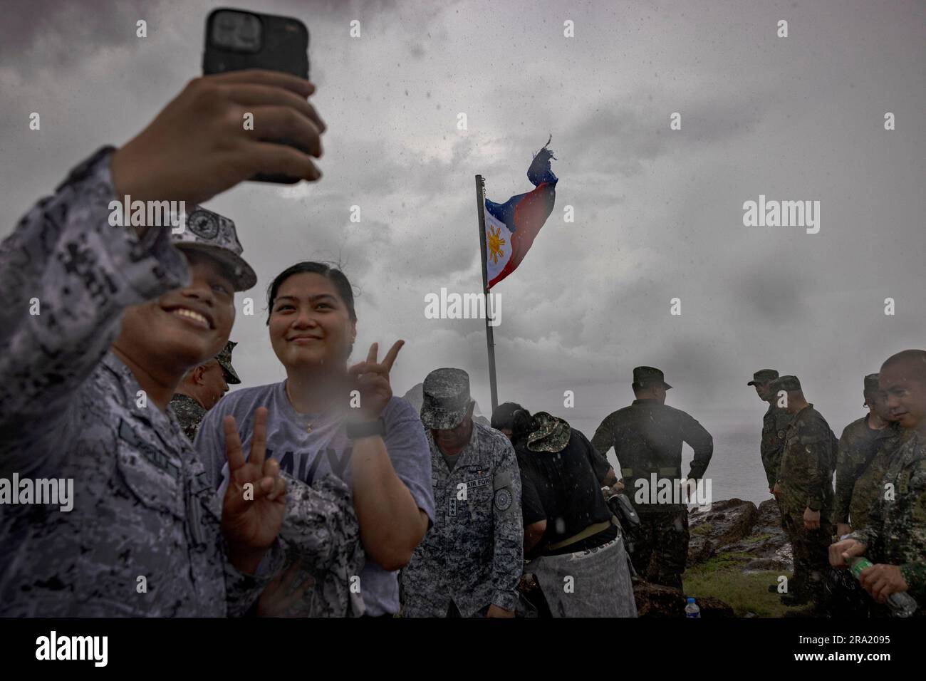 Filipino soldiers take pictures next to a Philippine flag on Thursday ...