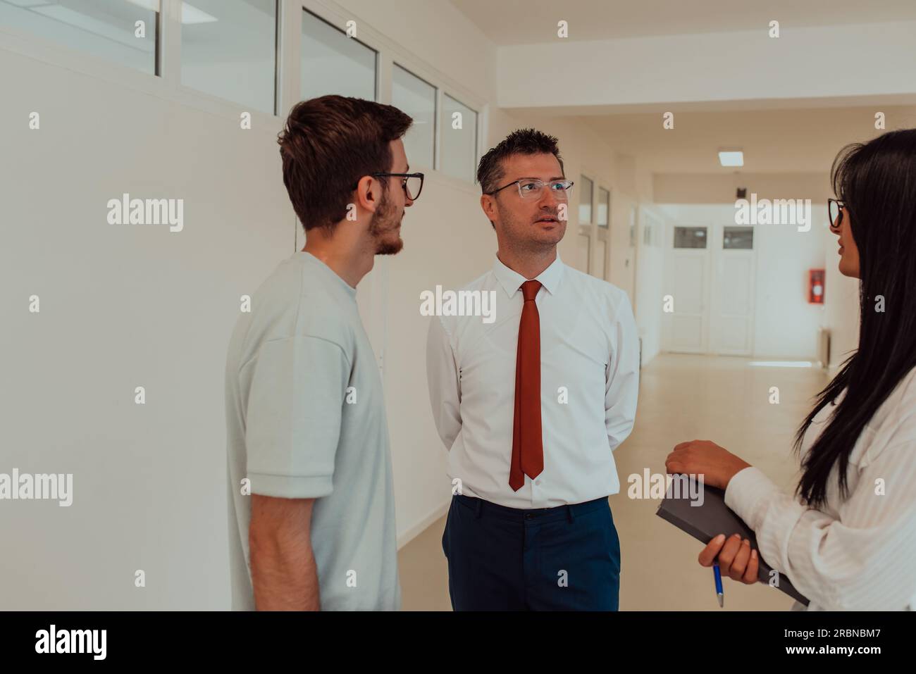 Der Direktor führt ein Gespräch mit der Sekretärin und einem jungen Programmierer in einem ...