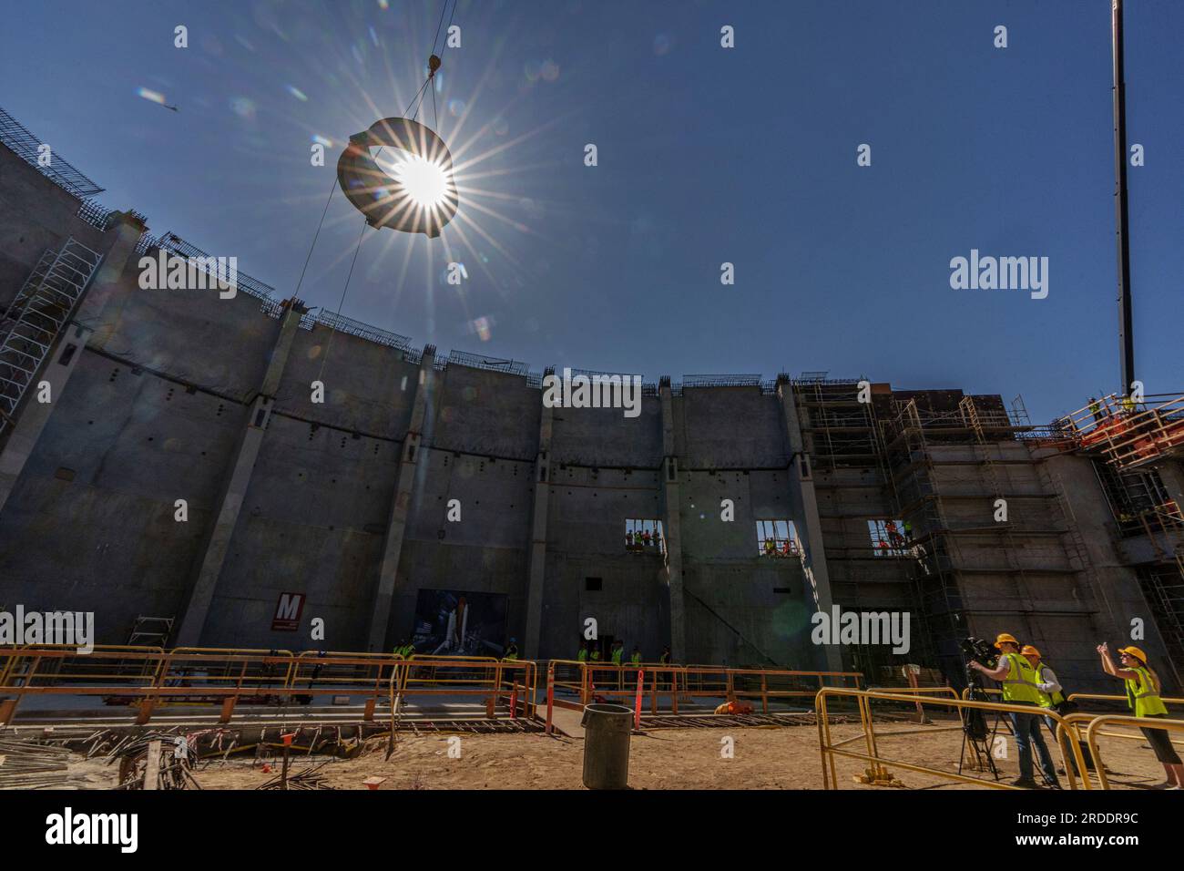 Workers use a crane to hoist one of the two Space Shuttle Endeavour's ...