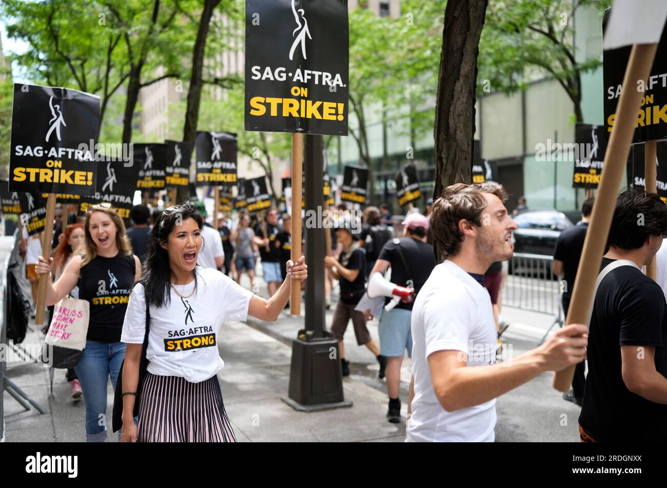 Picketers carry signs outside NBC in Rockefeller Center on Friday, July ...