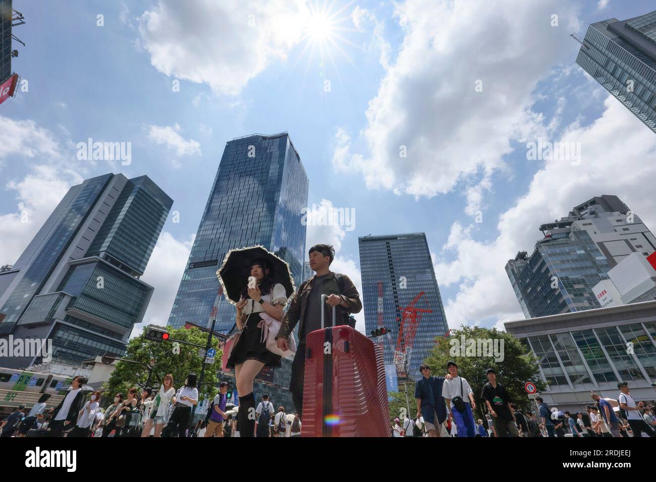 People walk on a street in Shibuya Ward, Tokyo, on July 22, 2023. The ...