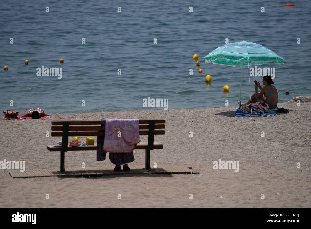 People enjoy the sea during a heat wave at Flisvos beach, in southern ...