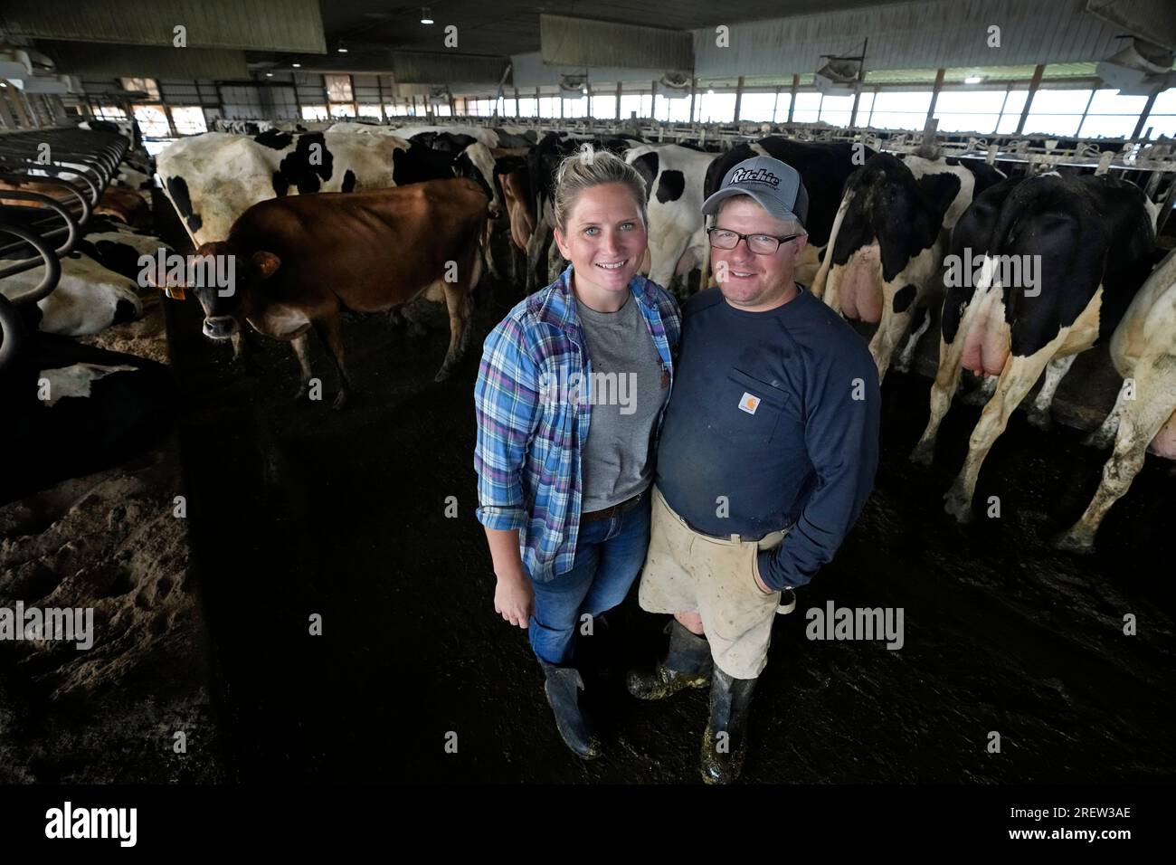 Dairy farmers Megan and Ted McAllister stand in the freestall barn on ...