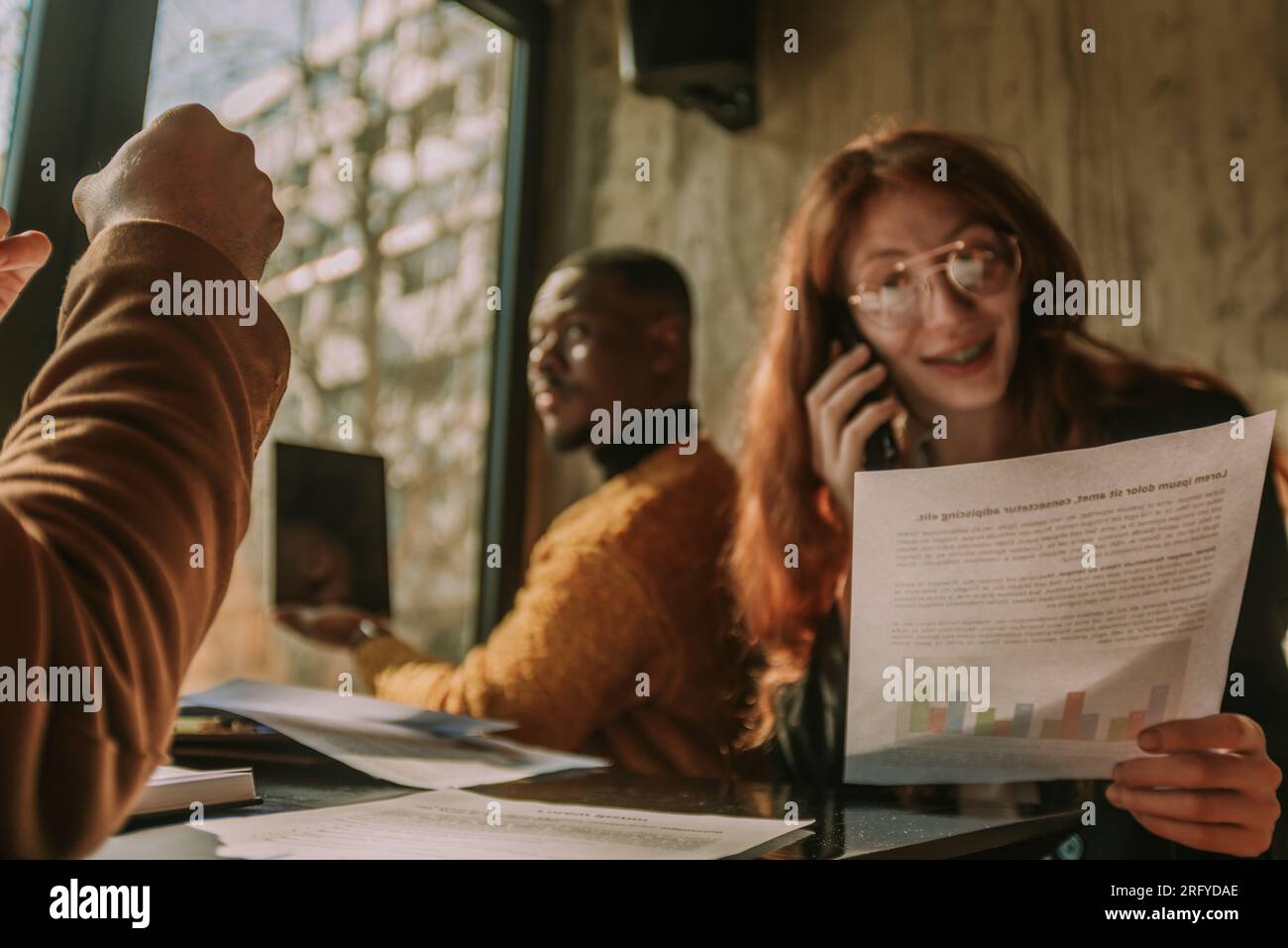 Rothaarige Geschäftsfrau, die sich das Dokument ansieht, während sie ...