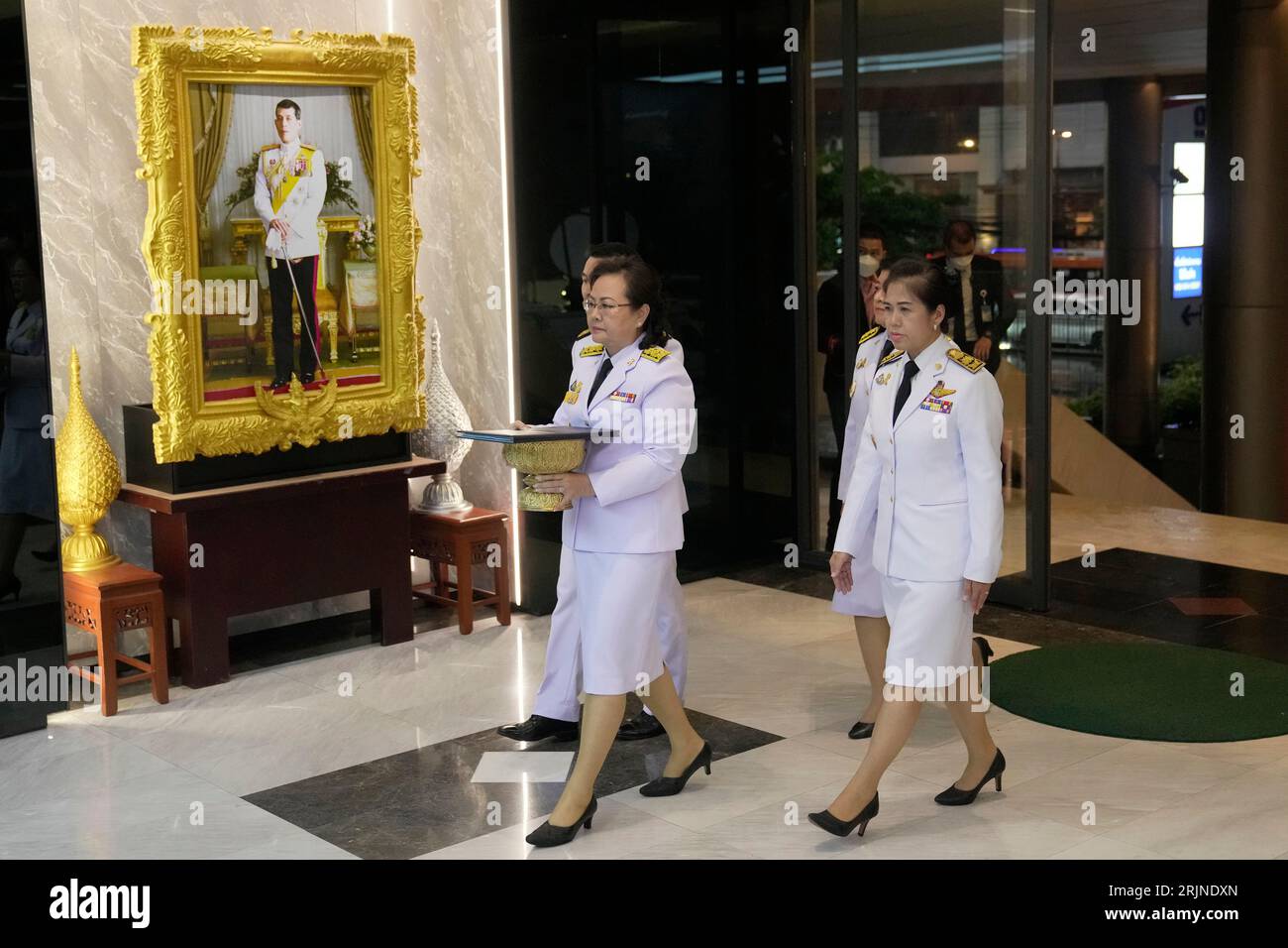 Officer hold royal endorsement beside the portrait of King Maha Vajiralongkorn before the royal ...
