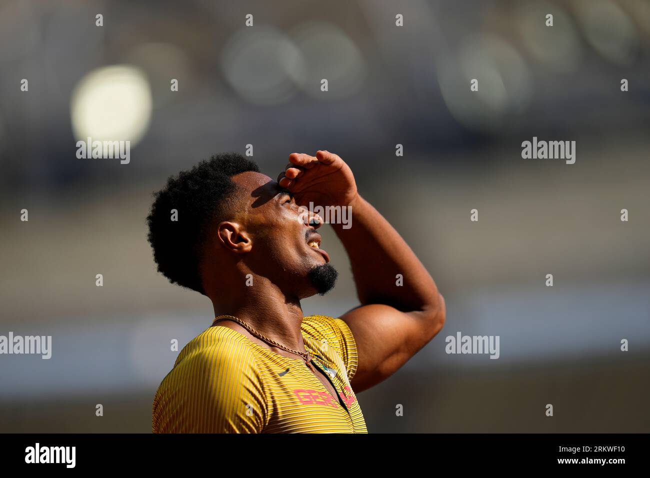 Leo Neugebauer, of Germany shields his eyes as he looks at his score ...
