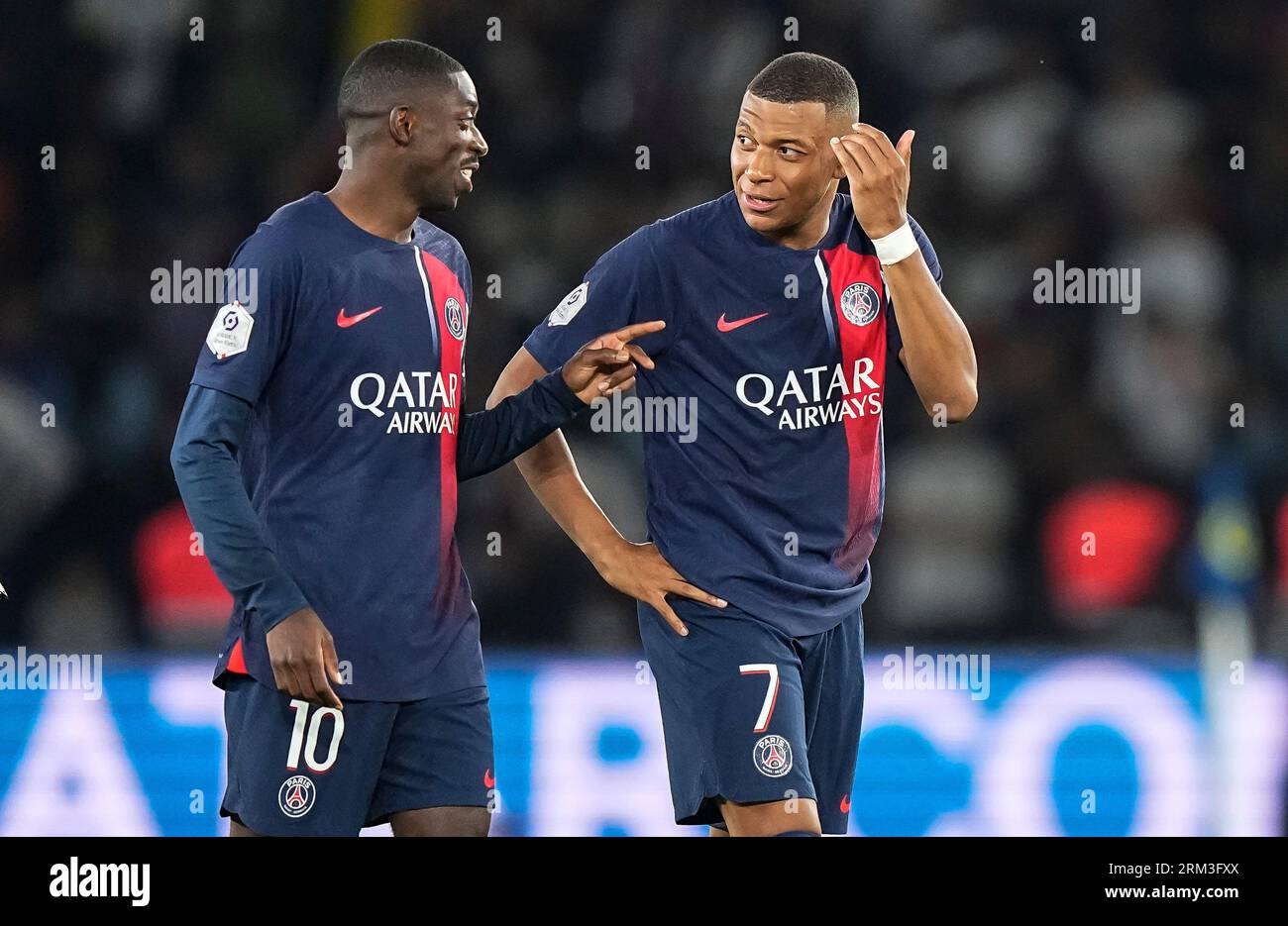 PSG's Ousmane Dembele, left, and Kylian Mbappe talk after the French ...