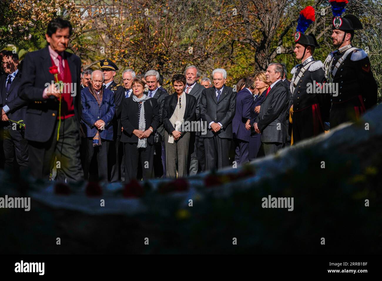 Lautaro Videla, left, walks to place a flower on a monument in honor of ...