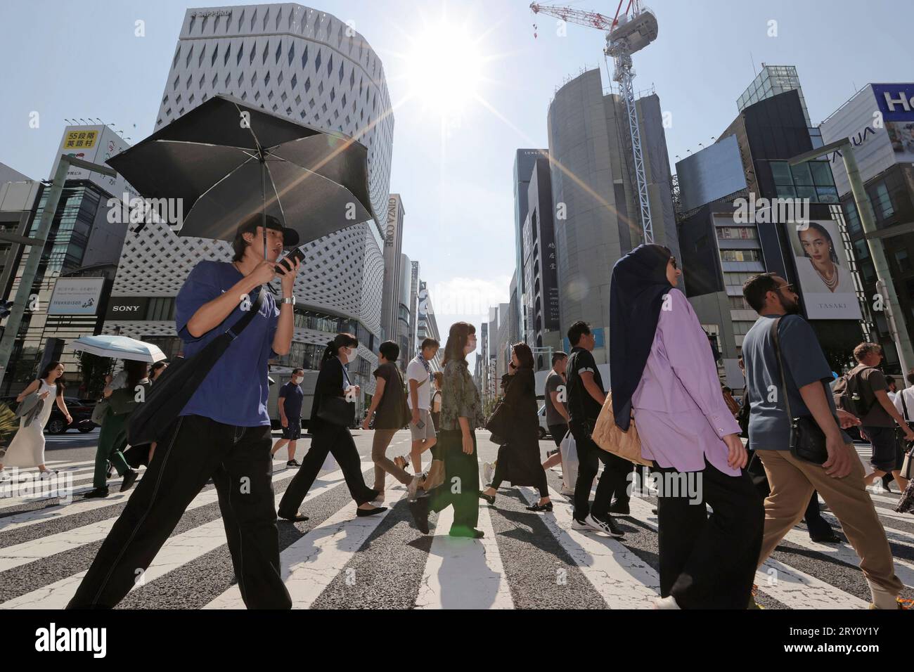People walk while sweltering hot at Ginza district in Tokyo on ...