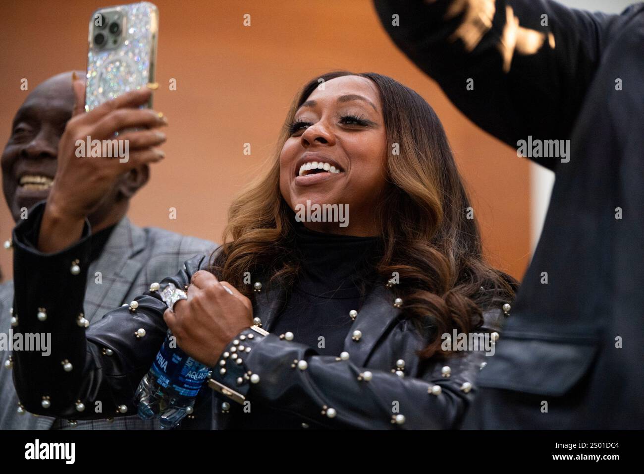 Kijafa Vick, the wife of Mike Vick, looks on and smiles as her husband ...