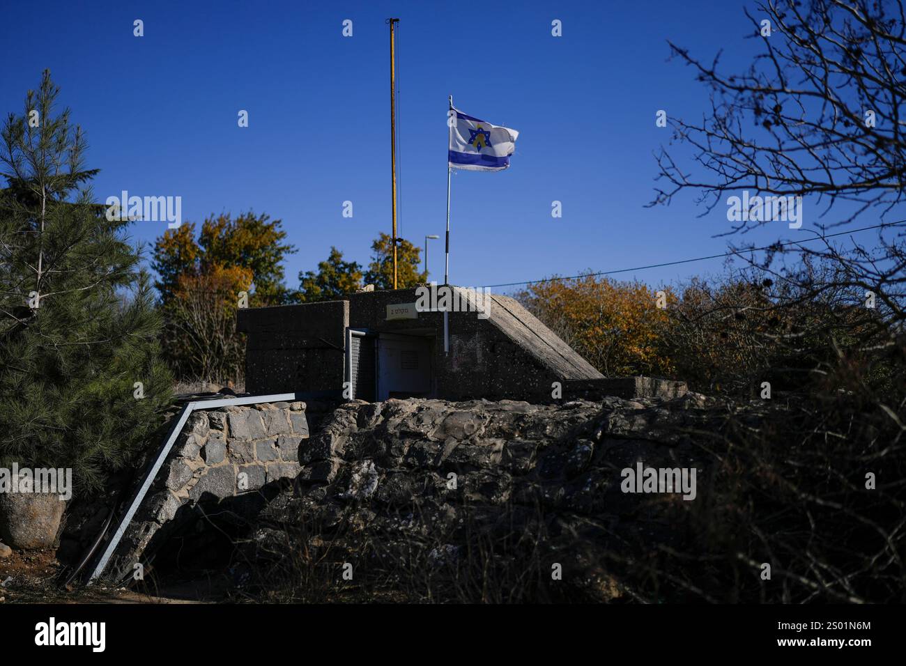 An Israeli flag flies on top of the entrance of a bomb shelter in the ...