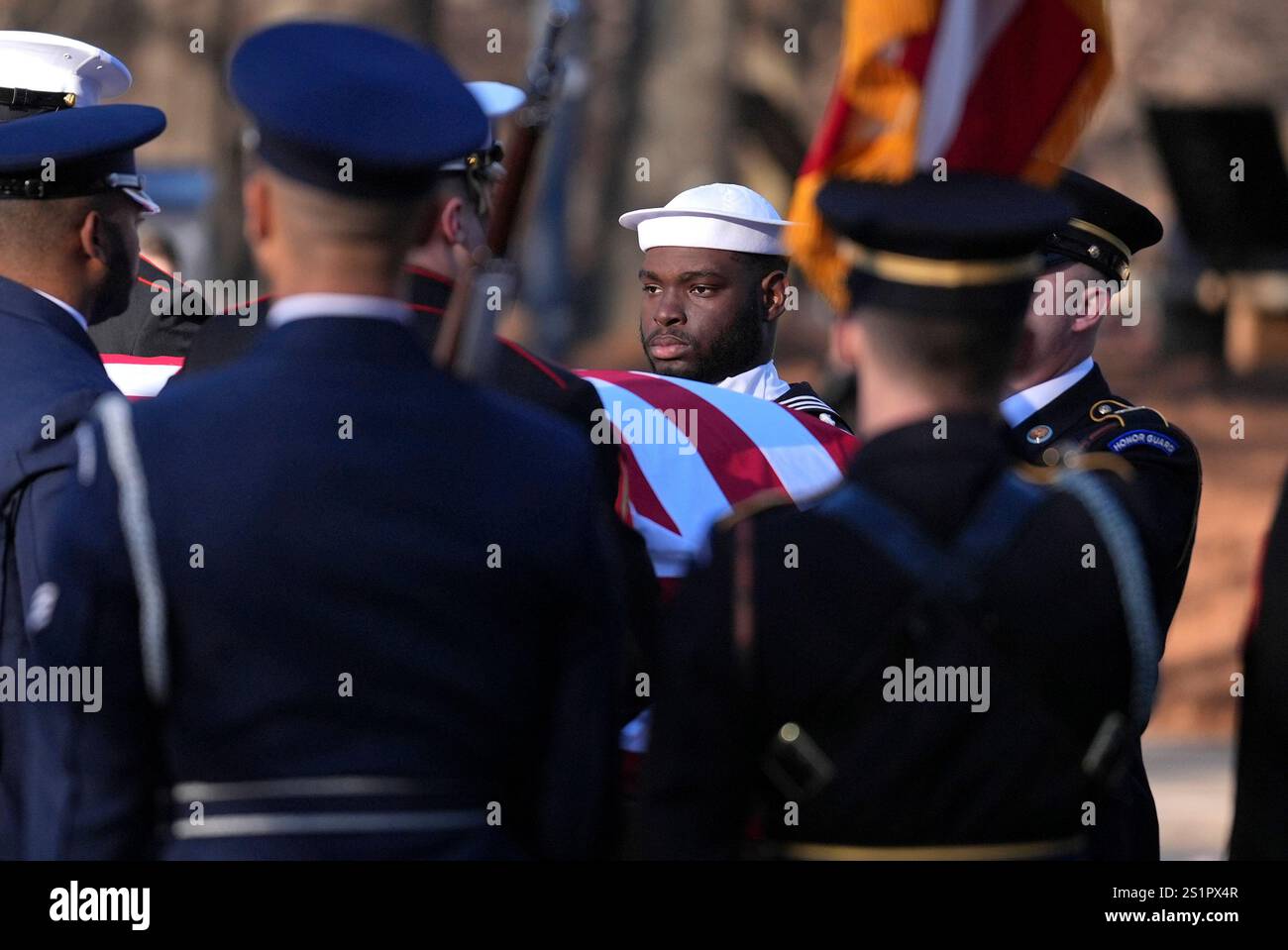 A military body bearer team moves the casket of former President Jimmy ...
