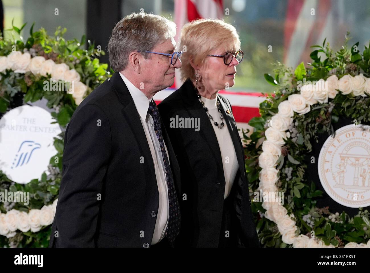 James "Chip" Carter and his wife Becky, depart after a service for ...