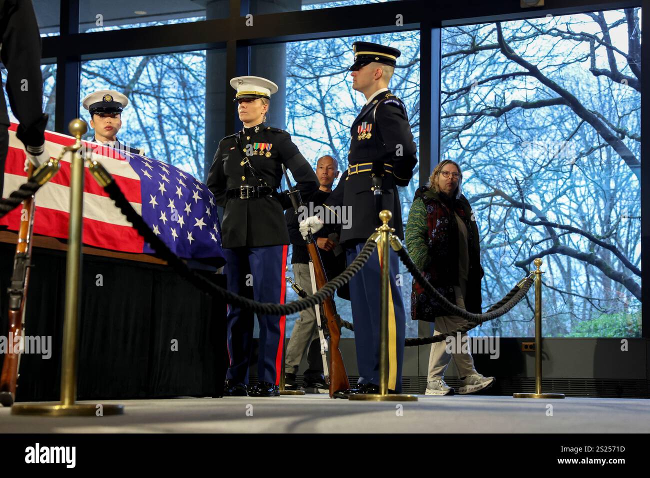 Members of the joint services military honor guard stand by the casket bearing the remains of ...