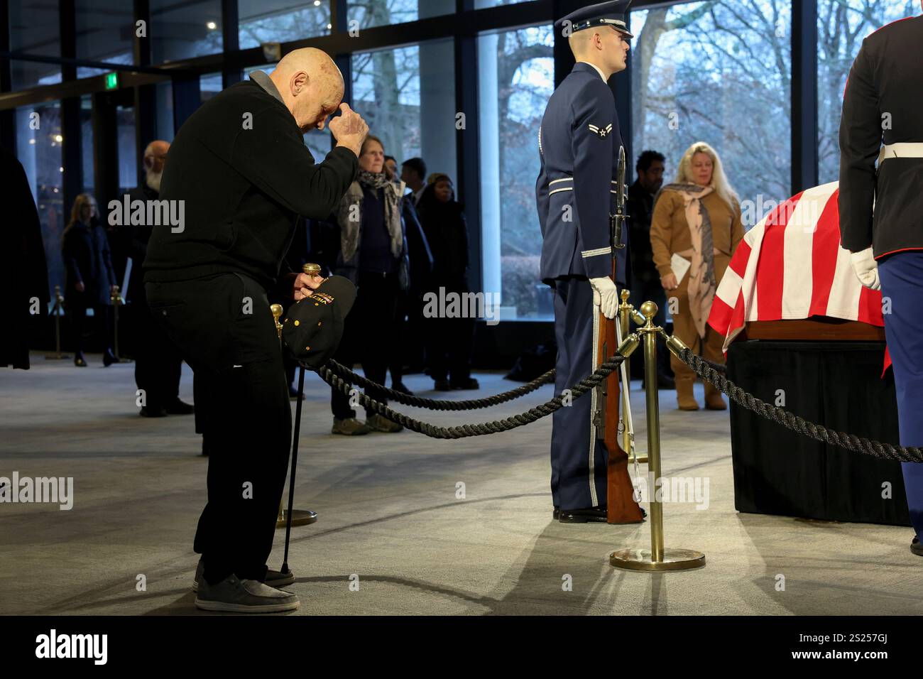 Members of the joint services military honor guard stand by the casket bearing the remains of ...