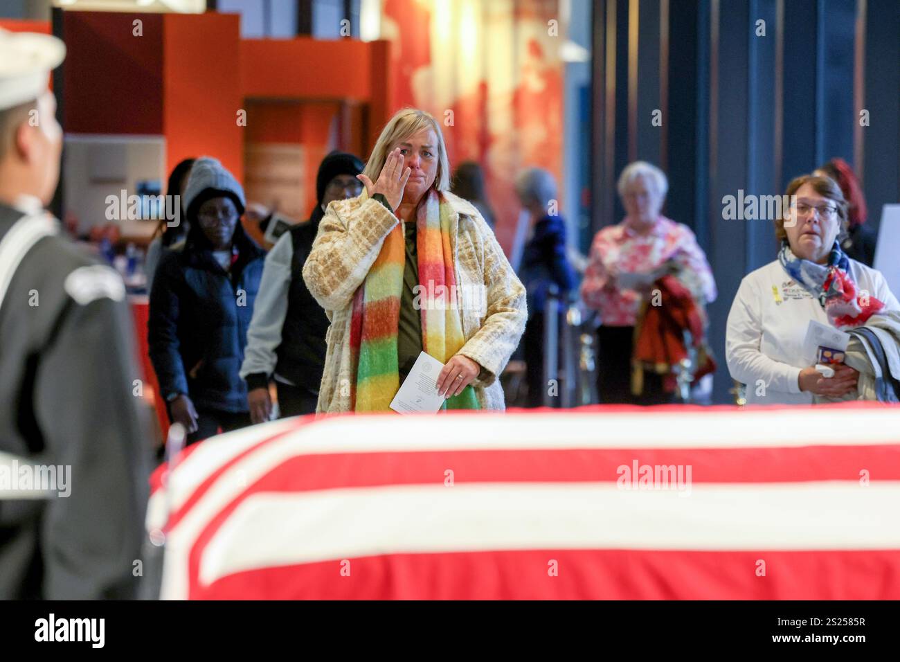Members of the joint services military honor guard stand by the casket bearing the remains of ...