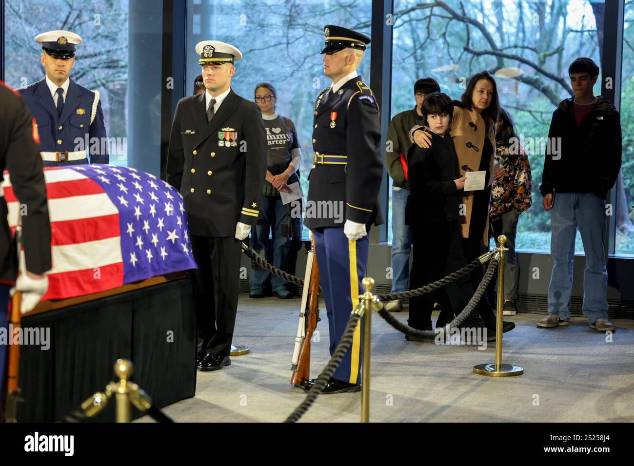 Members of the joint services military honor guard stand by the casket bearing the remains of ...