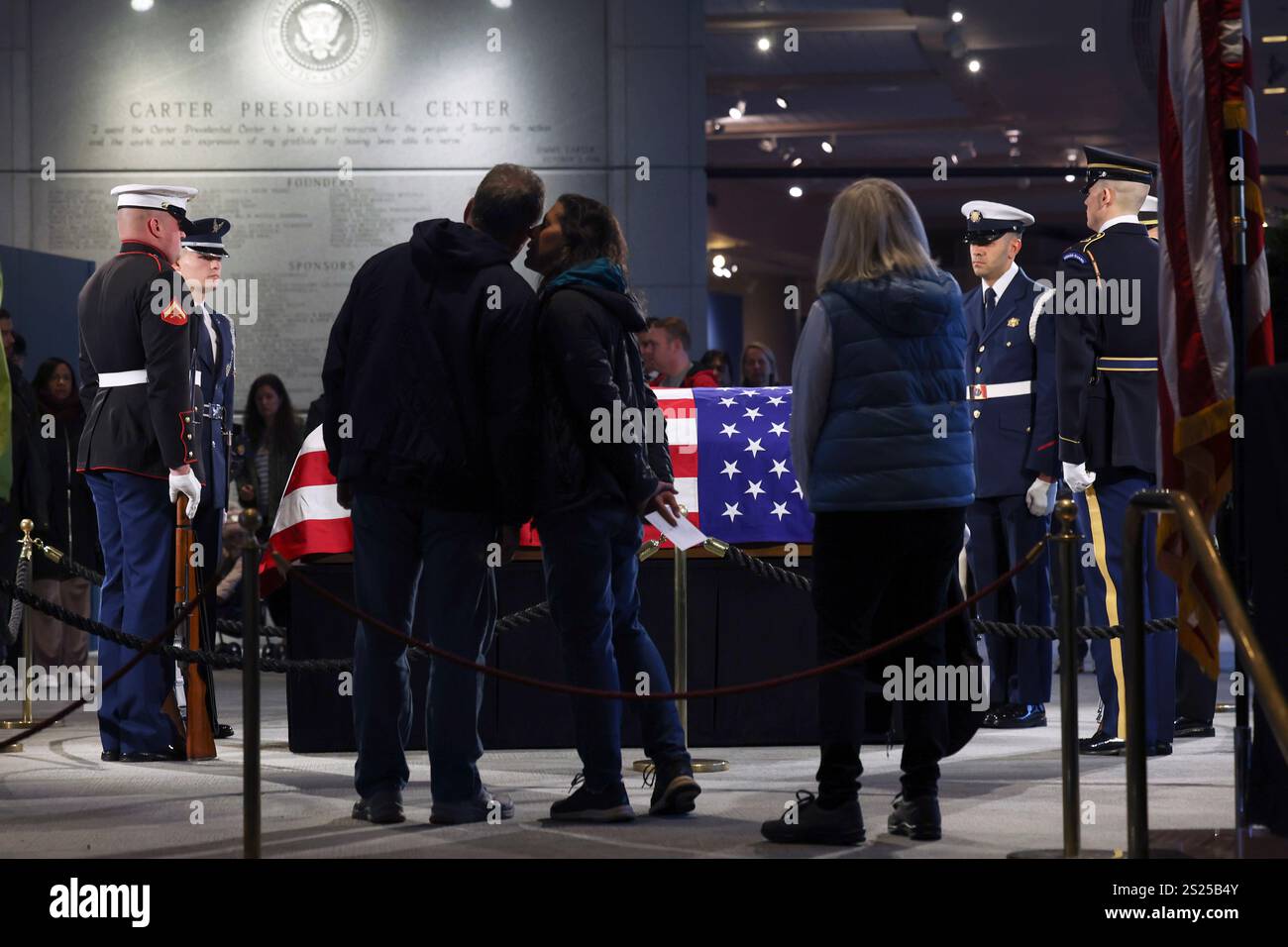 Members of the joint services military honor guard stand by the casket bearing the remains of ...