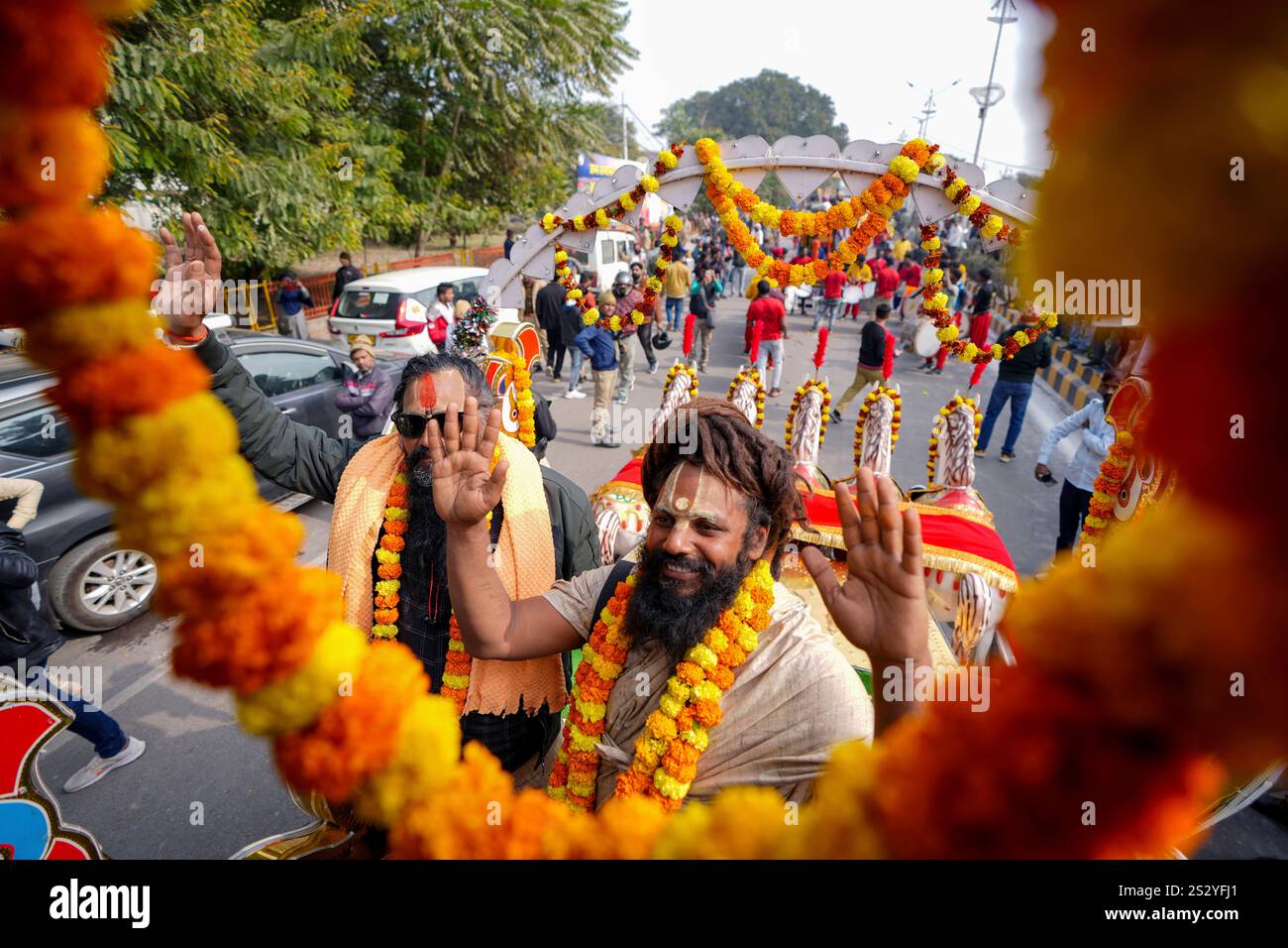 Hindu holy men participate in a procession towards the Sangam, the ...