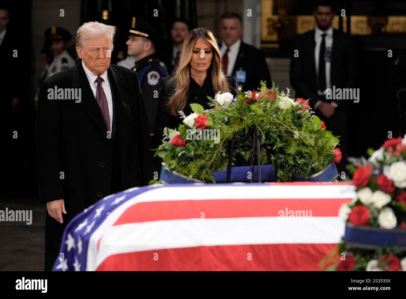 President-elect Donald Trump and Melania Trump pause at the flag-draped ...