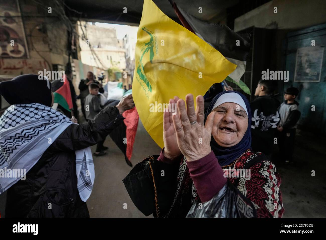 Palestinians wave Hezbollah and Palestinian flags as they celebrate a ...