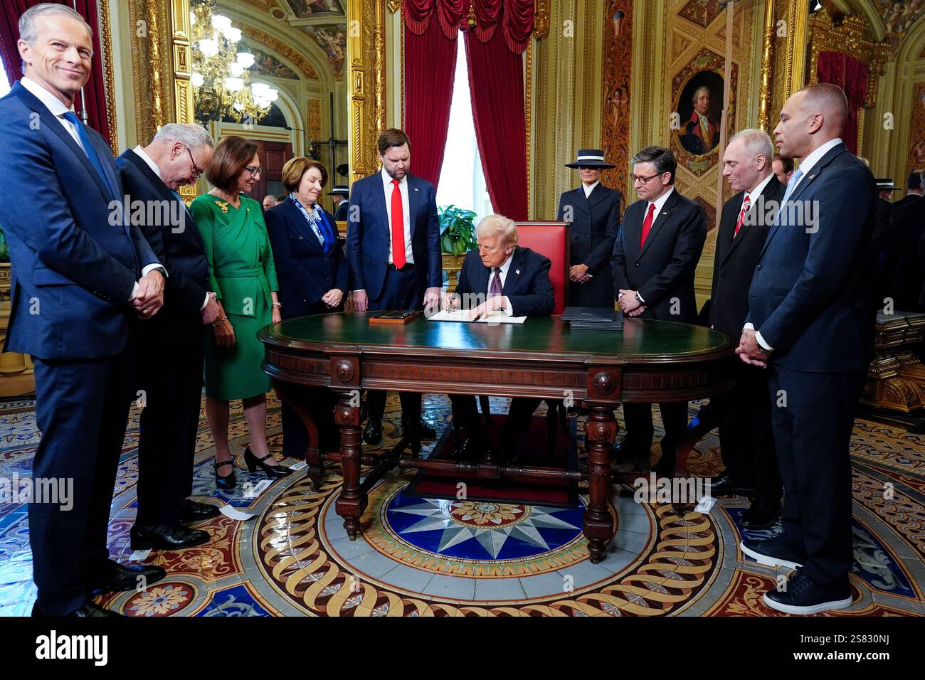 President Donald Trump, center, takes part in a signing ceremony in the ...