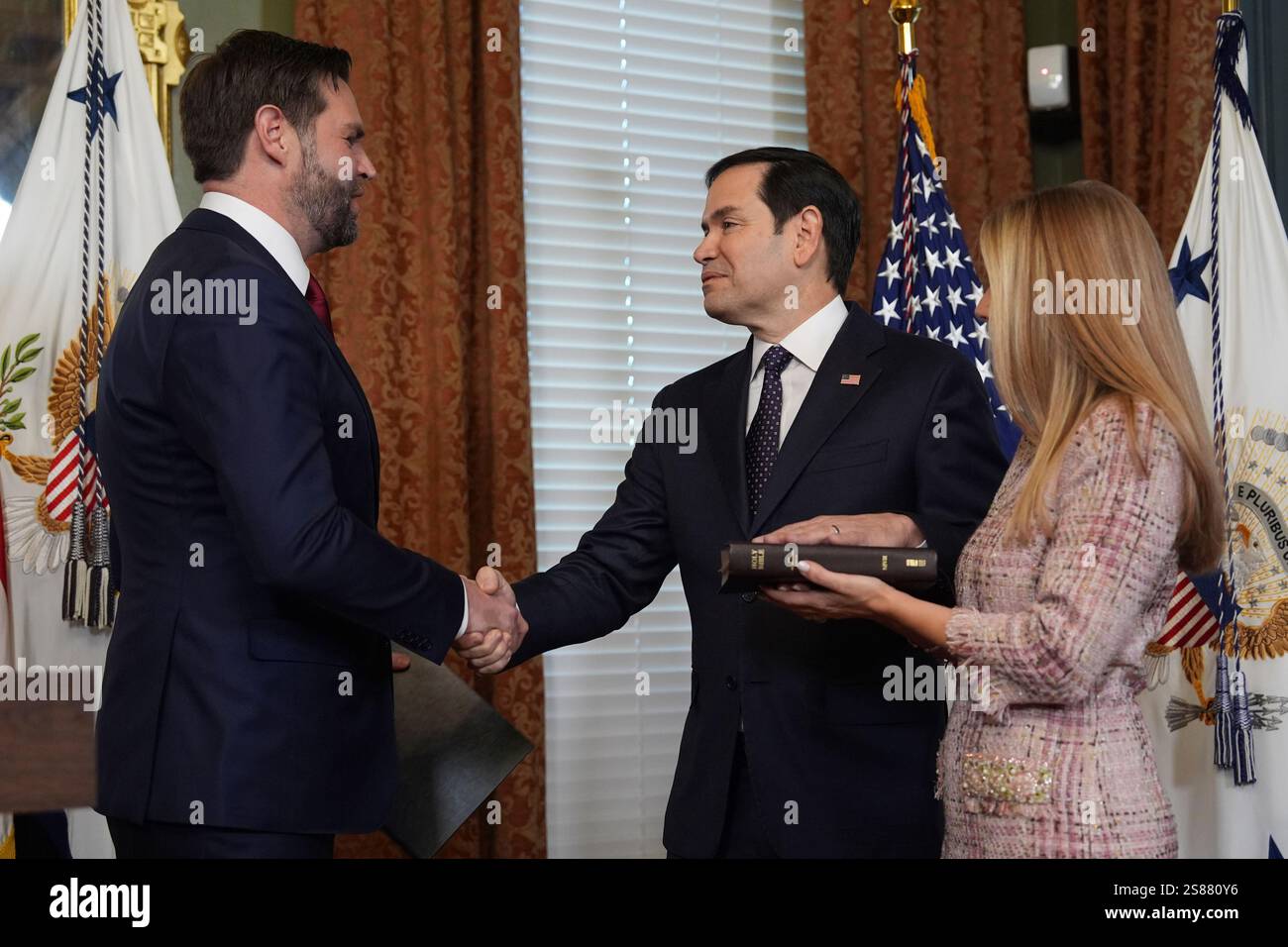 Secretary of State Marco Rubio shakes hands with Vice President JD Vance, after being sworn in ...