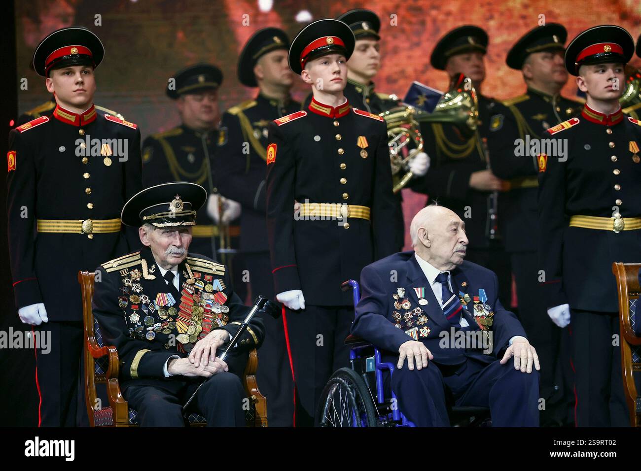Two WWII veterans listen to Russian President Vladimir Putin after awarding them with jubilee ...