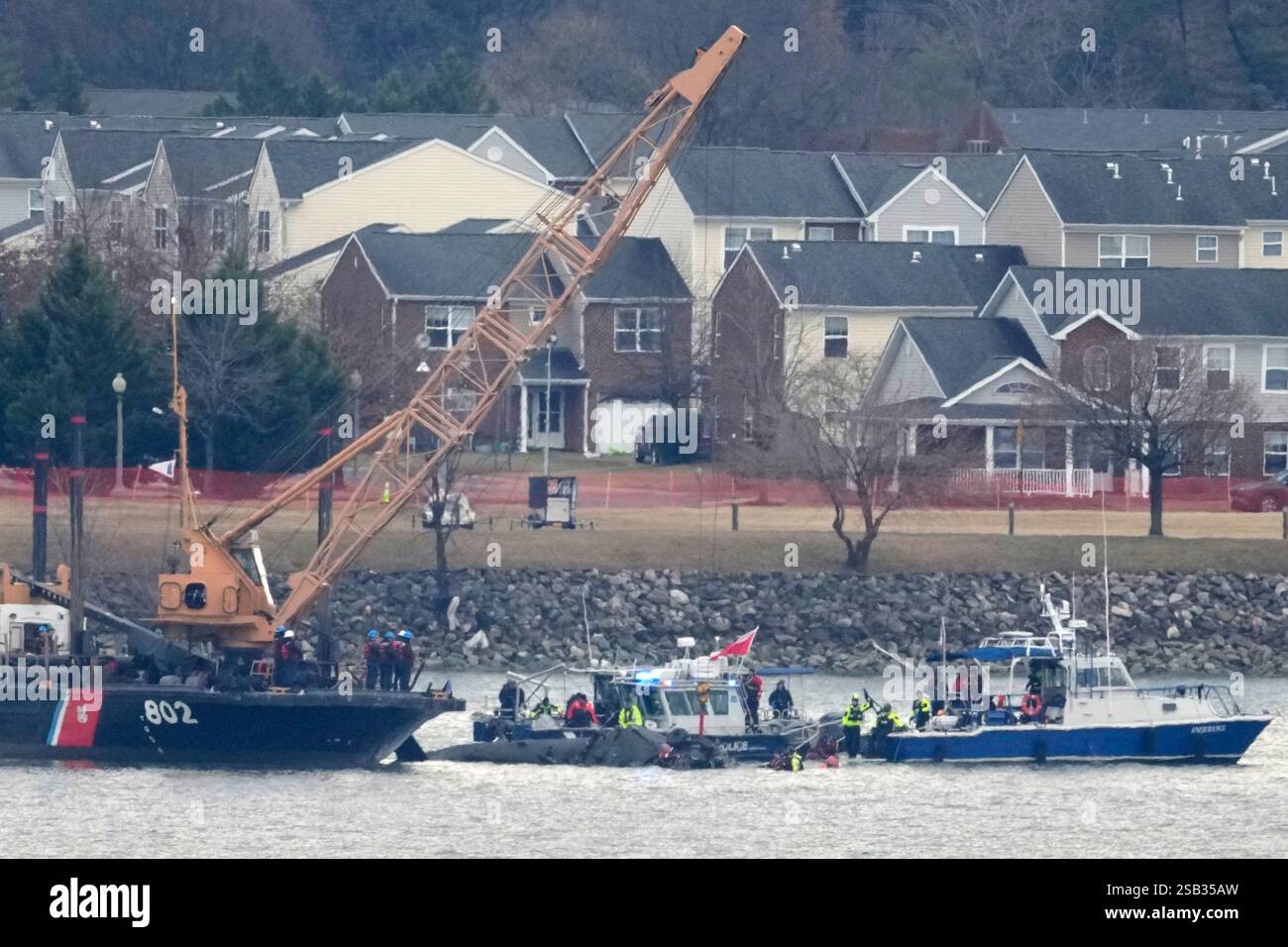 A Coast Guard vessel with a crane is pictured as it works near the ...