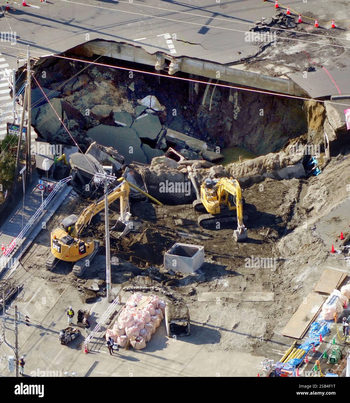 An aerial photo shows sinkholes at an intersection in Yashio City ...