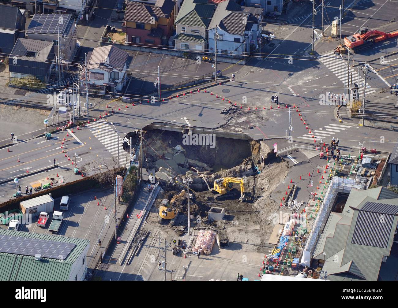 An aerial photo shows sinkholes at an intersection in Yashio City ...