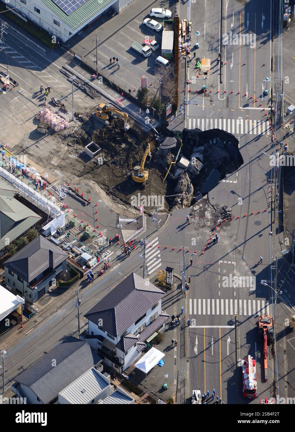 An aerial photo shows sinkholes at an intersection in Yashio City ...