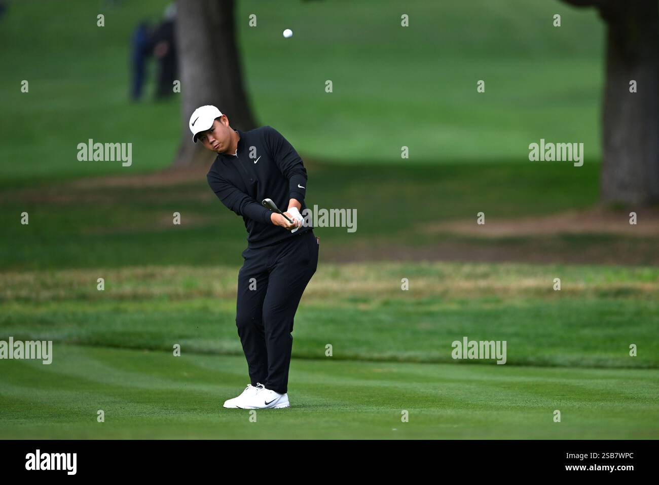 Tom Kim, of South Korea, hits a fairway shot on the second hole at ...