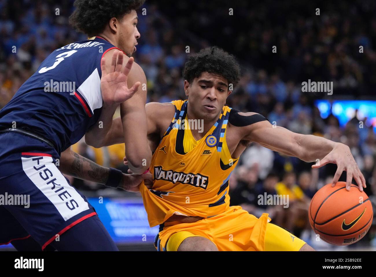 Marquette's Stevie Mitchell tries to get past UConn's Jaylin Stewart ...