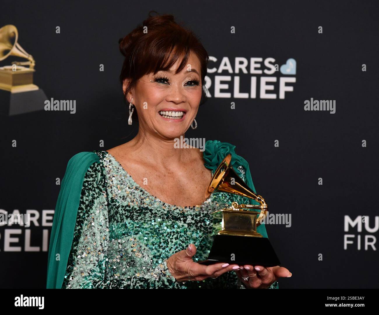Mimy Succar poses in the press room with the award for best tropical latin album for "Alma ...