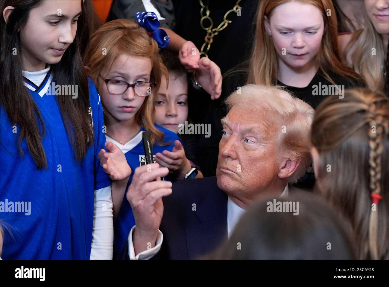 President Donald Trump hands out pens after signing an executive order ...