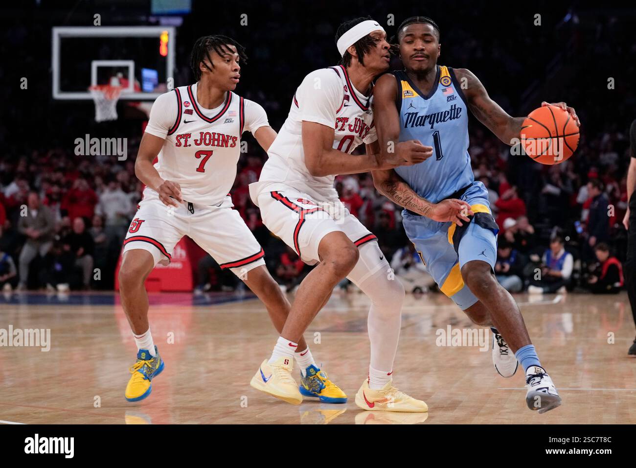Marquette's Kam Jones, right, pushes past St. John's Aaron Scott ...