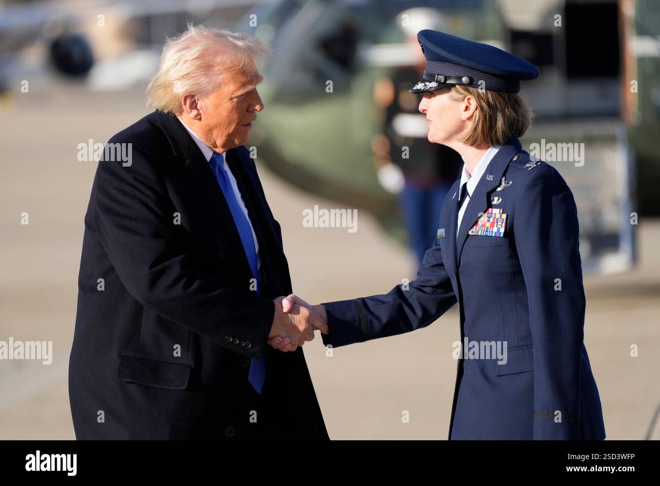 President Donald Trump shakes hands with Col. Angela Ochoa, commander ...