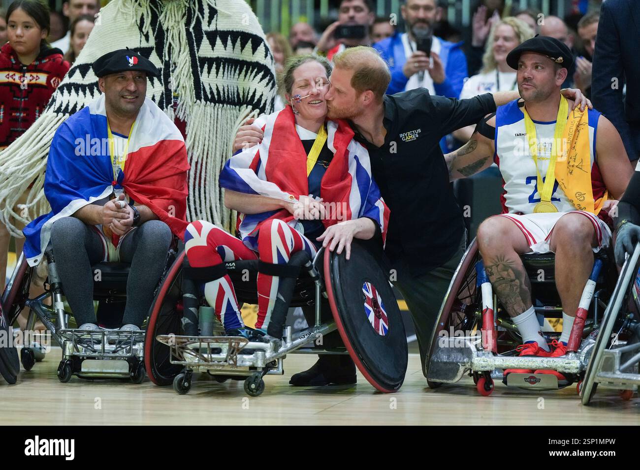 Britain's Prince Harry, the Duke of Sussex, kisses silver medallist ...