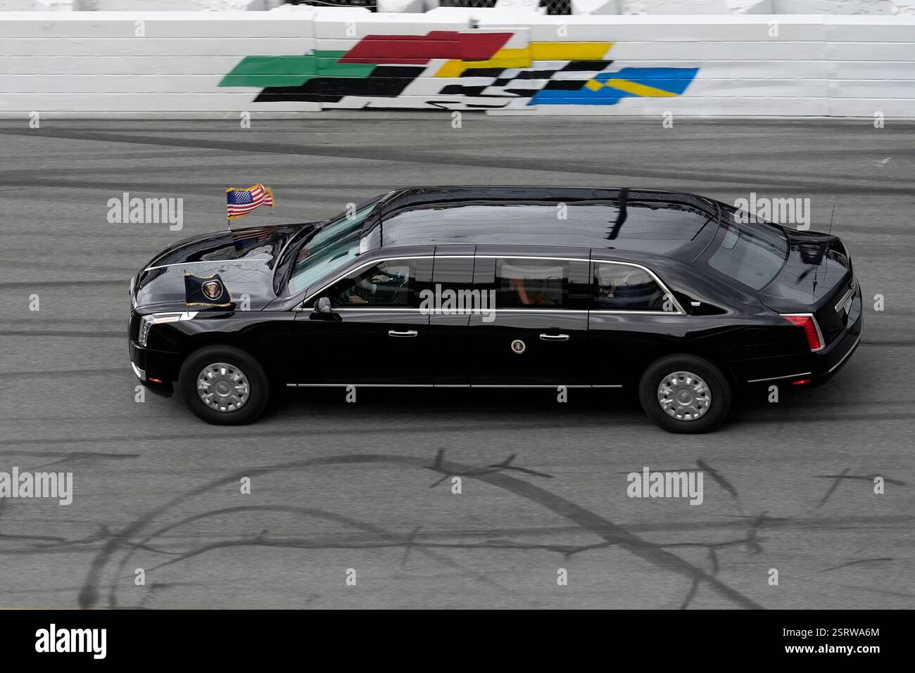 President Donald Trump rides in the presidential limousine known as ...
