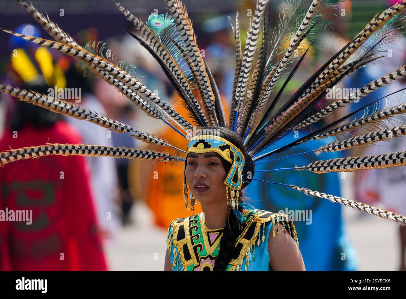A woman in Indigenous dress attends a state funeral ceremony ...