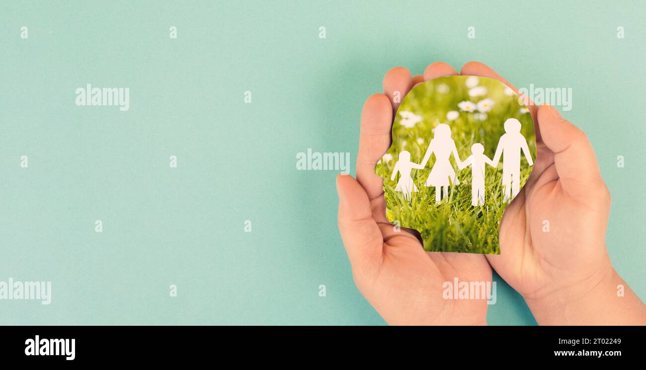 Eltern mit Kindern, die auf einer Wiese laufen und Hände halten ...