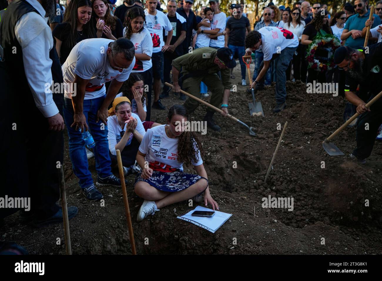 Mourners gather around the graves of British-Israelis Lianne Sharabi ...